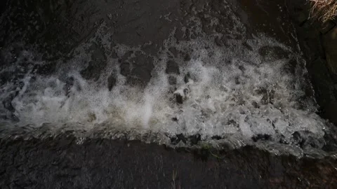 Top view of water flows from a small can... | Stock Video | Pond5