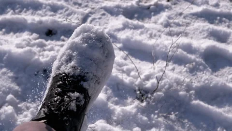 Top View Woman Shakes Snow off Black Boo... | Stock Video | Pond5