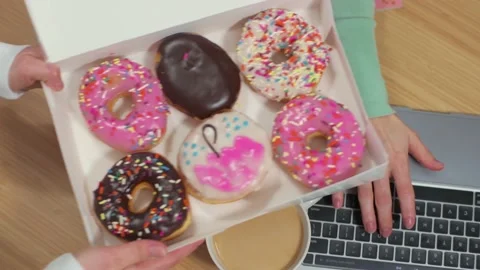 Top view like a woman taking donuts out ... | Stock Video | Pond5