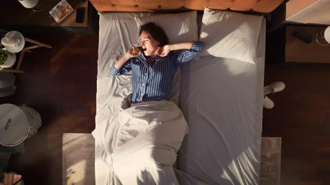 Top View woman Waking up | Stock Video | Pond5