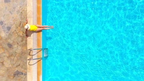 Top view of a woman in yellow swimsuit a... | Stock Video | Pond5