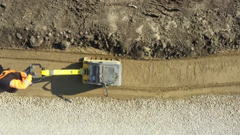 Top view worker compacting foundation us... | Stock Video | Pond5