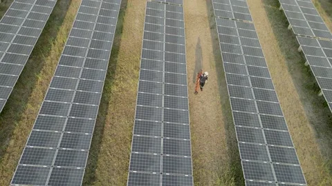 Top view of worker walking in solar farm... | Stock Video | Pond5