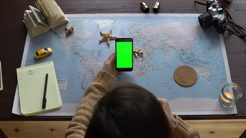 Top view. World map on the table, a woma... | Stock Video | Pond5