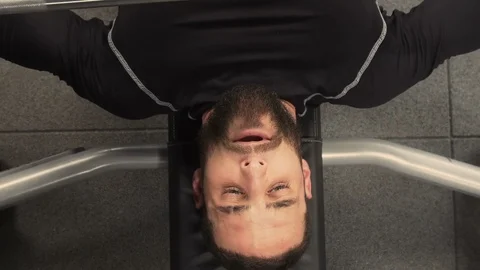 Top view of young man doing bench press ... | Stock Video | Pond5