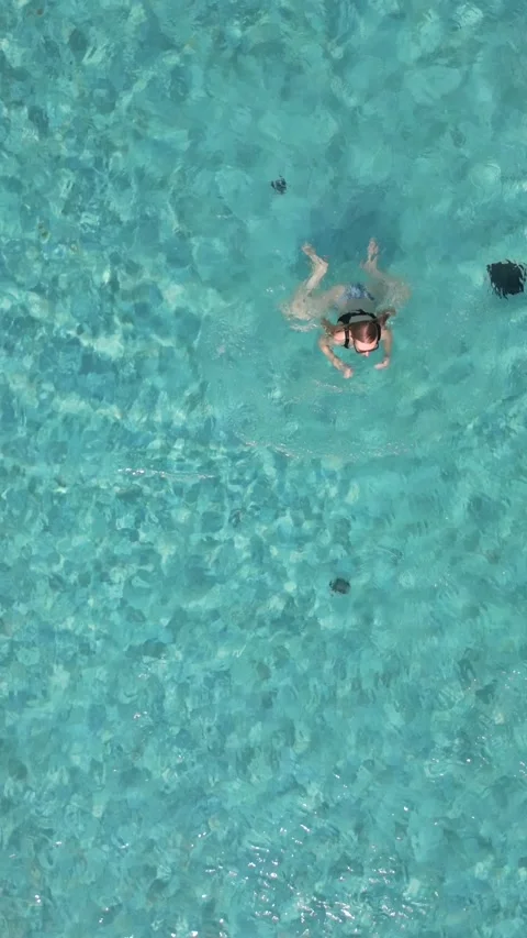 Top view of a young woman swimming in th... | Stock Video | Pond5
