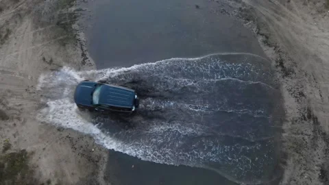 Car Driving Through Water Stock Footage ~ Royalty Free Stock Videos | Pond5