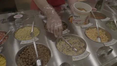 toppings added to cup noodle ramen | Stock Video | Pond5