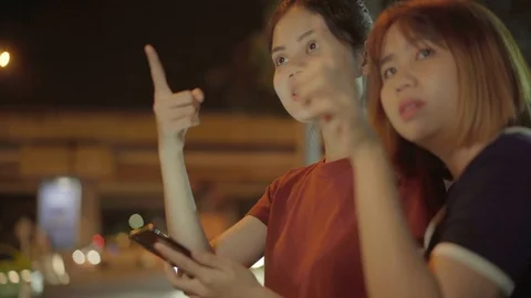 Tourist Asian sister girls direction on ... | Stock Video | Pond5
