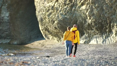 A tourist girl and a man in a warm yello... | Stock Video | Pond5