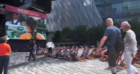 Tourists watching tennis game in giant m... | Stock Video | Pond5