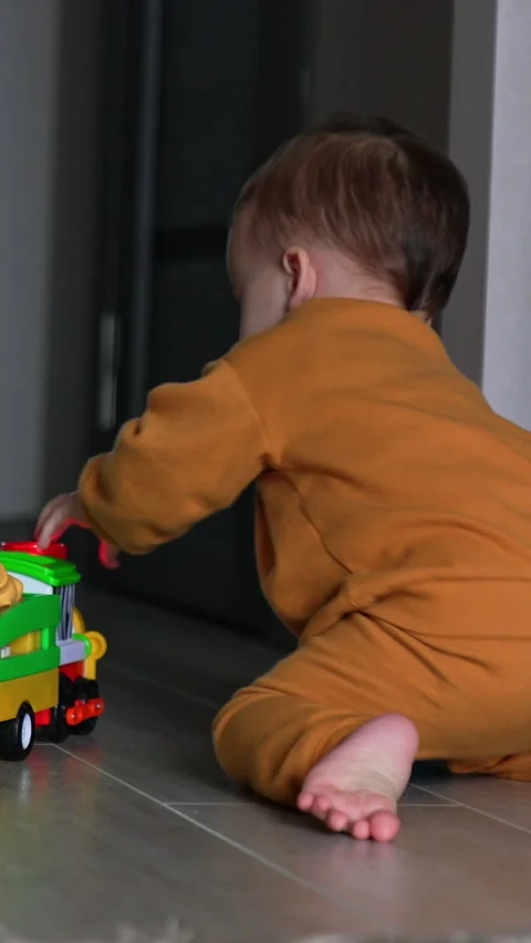 Toy car is moving by the floor and baref... | Stock Video | Pond5