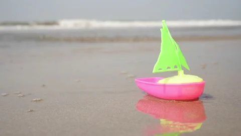 Toy plastic ship or boat with a sail on ... | Stock Video | Pond5