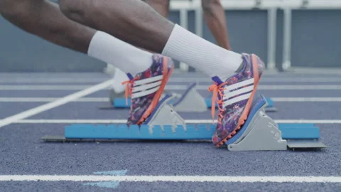 Track Athletes Step Into Blocks On Track | Stock Video | Pond5