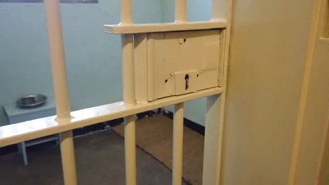 Tracking into a closeup of a cell door l... | Stock Video | Pond5