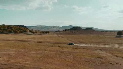 Tracking drone shot of a black car drivi... | Stock Video | Pond5