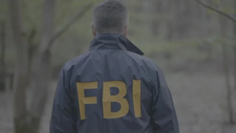 Tracking shop behind FBI agent walking f... | Stock Video | Pond5