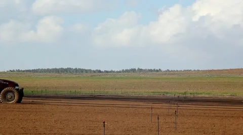 Tractor in the Field- passing the frame ... | Stock Video | Pond5