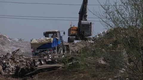 A tractor with garbage drives through a ... | Stock Video | Pond5