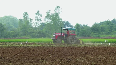 tractor ploughing in the farm field for ... | Stock Video | Pond5