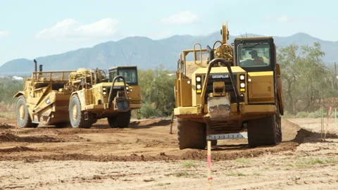 Tractor Scrapers moving dirt and grading... | Stock Video | Pond5
