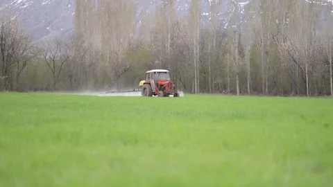 A Tractor Spraying Agricultural Land | Stock Video | Pond5