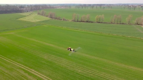Tractor spraying wheat grain crops growi... | Stock Video | Pond5
