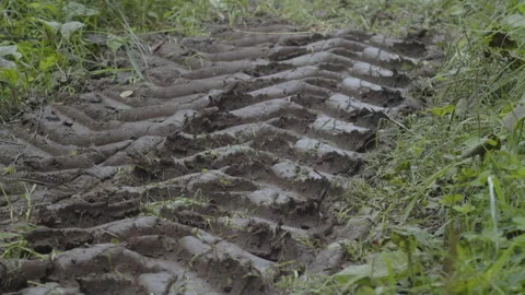 Tractor wheel trail in the field 4K foot... | Stock Video | Pond5