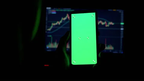 A Trader Holds a Smartphone with a Green... | Stock Video | Pond5