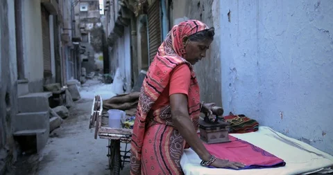 Traditional Indian Lady ironing clothes ... | Stock Video | Pond5