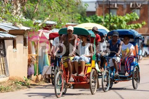 Traditional rickshaw on the city streets. Rickshaws are a common mode ...