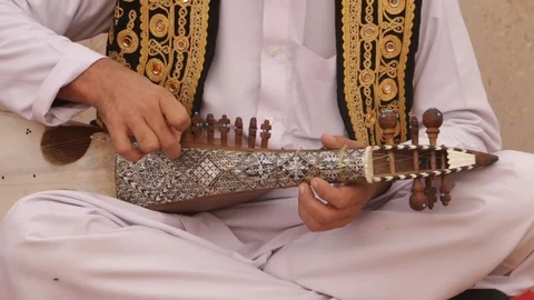 Traditional Rubab player tuning the inst... | Stock Video | Pond5