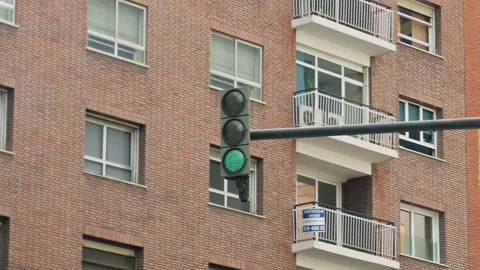 Traffic light changing lights with a bui... | Stock Video | Pond5