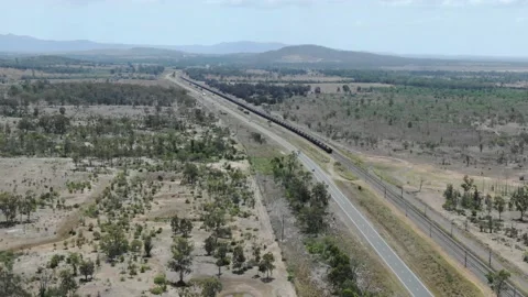 Train running on railway parallel to roa... | Stock Video | Pond5