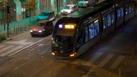 Tram rolling on rails at night in the st... | Stock Video | Pond5