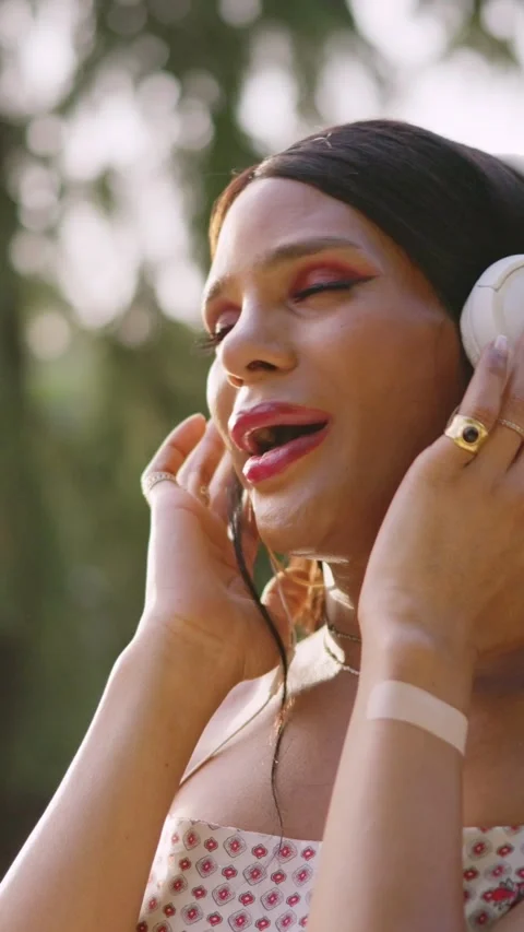 Trans woman listening music and singing ... | Stock Video | Pond5