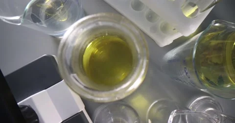 Transparent yellow oily liquid in test t... | Stock Video | Pond5