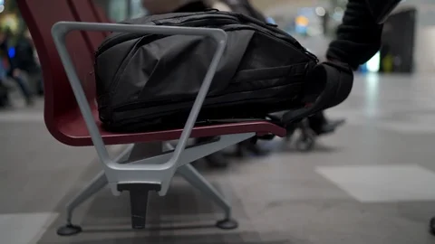 Travel backpack on bench at airport term... | Stock Video | Pond5