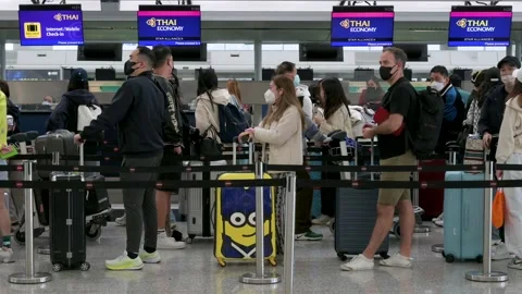 Travel passengers queue in line to check... | Stock Video | Pond5