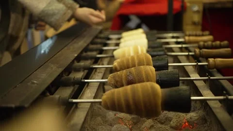 Trdelnik, pastries on spit over charcoal... | Stock Video | Pond5