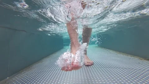 Treading water with bare feet in cold wa... | Stock Video | Pond5