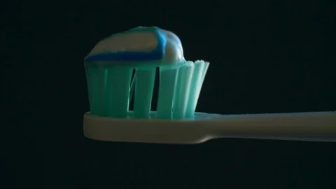 Tricolor toothpaste onto toothbrush on B... | Stock Video | Pond5