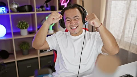 Triumphant young chinese streamer, heads... | Stock Video | Pond5