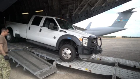Truck reversing up ramps of C-17 Globema... | Stock Video | Pond5