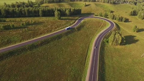 Trucks go on very steep turn on a windin... | Stock Video | Pond5