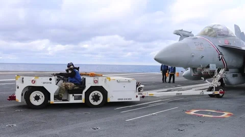 Tug towing U.S. Navy F/A-18 Hornet aircr... | Stock Video | Pond5