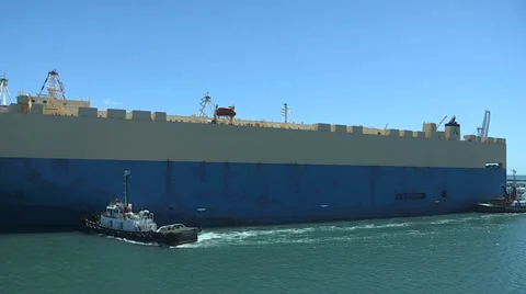 Tugboats pushing cargo ship | Stock Video | Pond5
