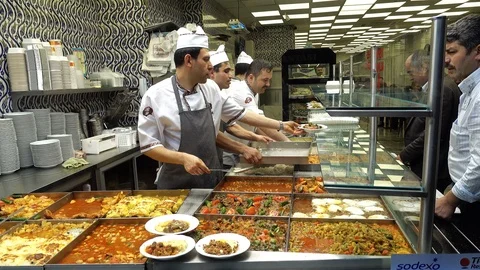 Turkish canteen. The cook puts food on t... | Stock Video | Pond5