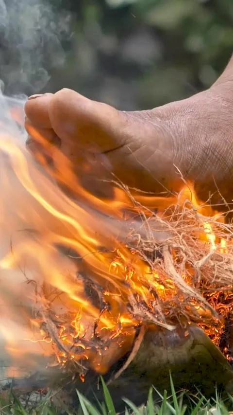 Turn off fire with bare feet. Step on fi... | Stock Video | Pond5