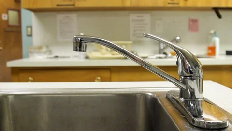Turning on a sink faucet to fill up a ki... | Stock Video | Pond5